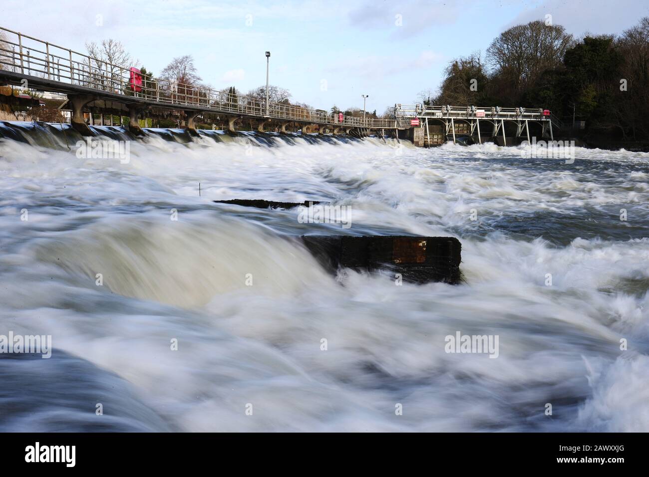 Fast flowing water passes through the weir at Ray Mill Island ...