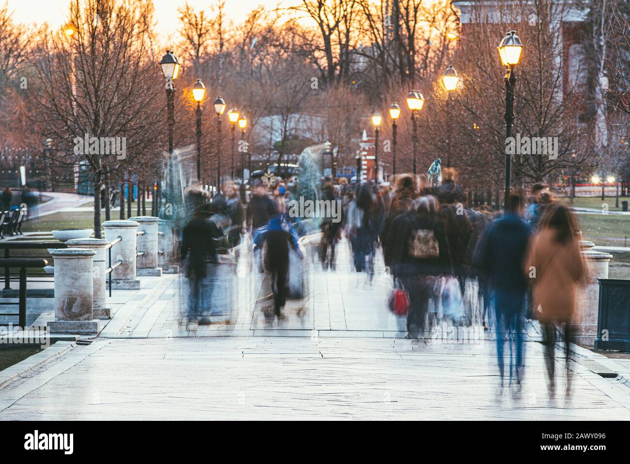 A crowd of people walking in the autumn Park. Blurred city background ...