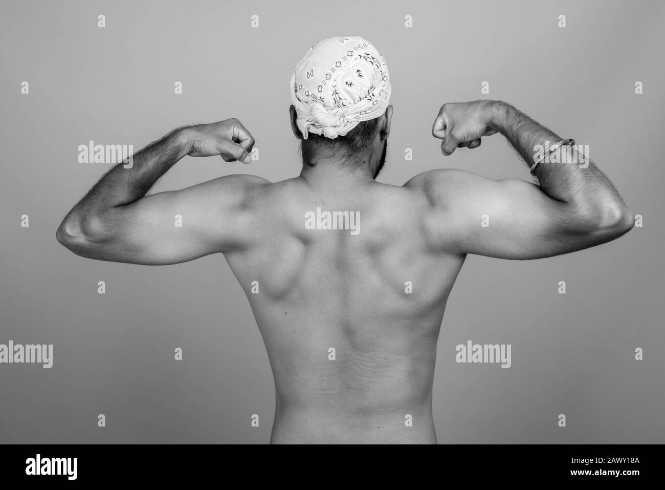 Rear view of young handsome Indian man shirtless Stock Photo - Alamy