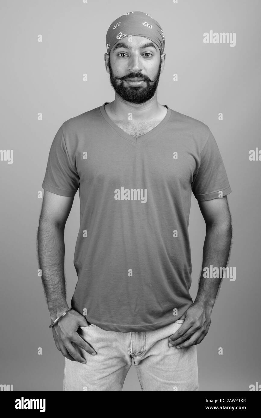 Portrait of young handsome bearded Indian man Stock Photo - Alamy