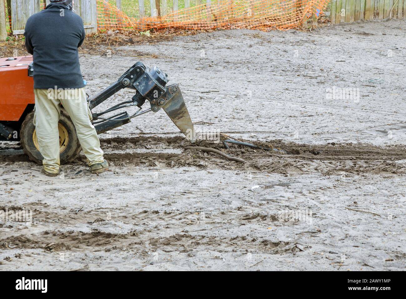Digging a pipe in the workers installing irrigation for water plants ...