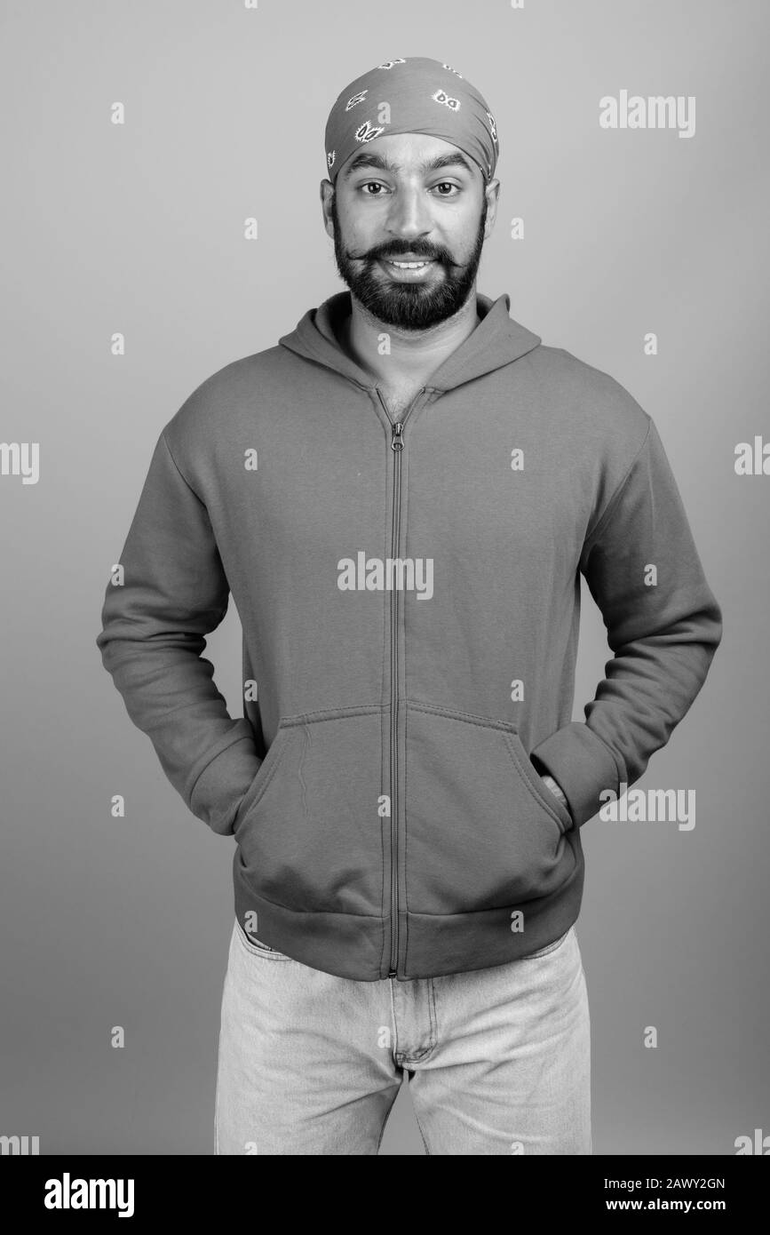 Portrait of young handsome bearded Indian man Stock Photo - Alamy