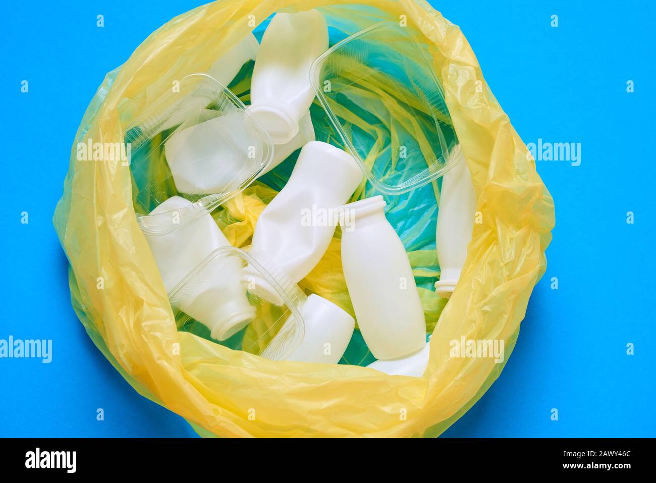 Horizontal from above flat lay shot of yellow plastic garbage bag with ...