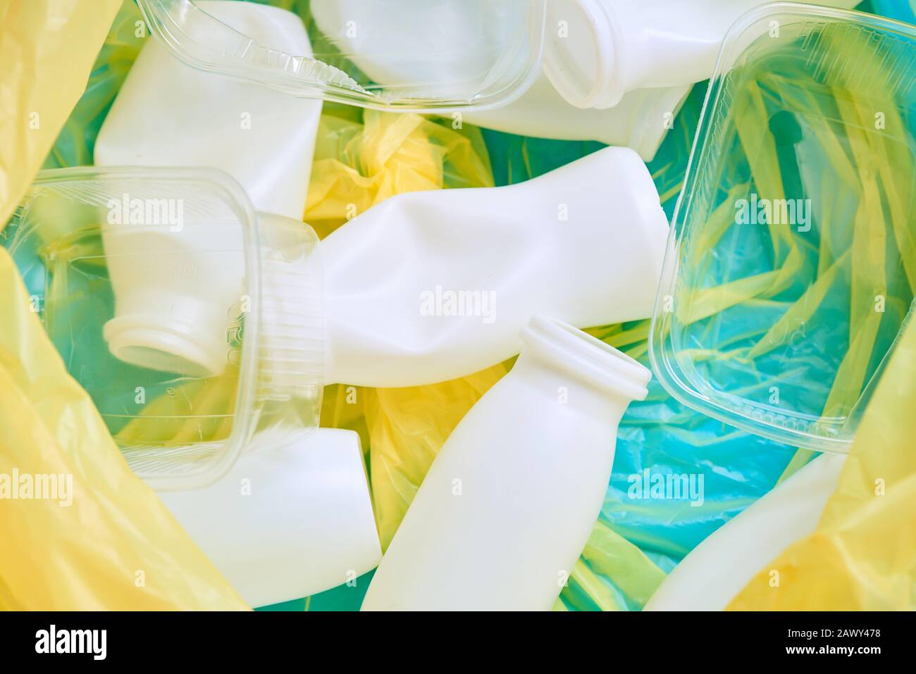 Empty plastic bottles and containers in yellow plastic garbage bag ...