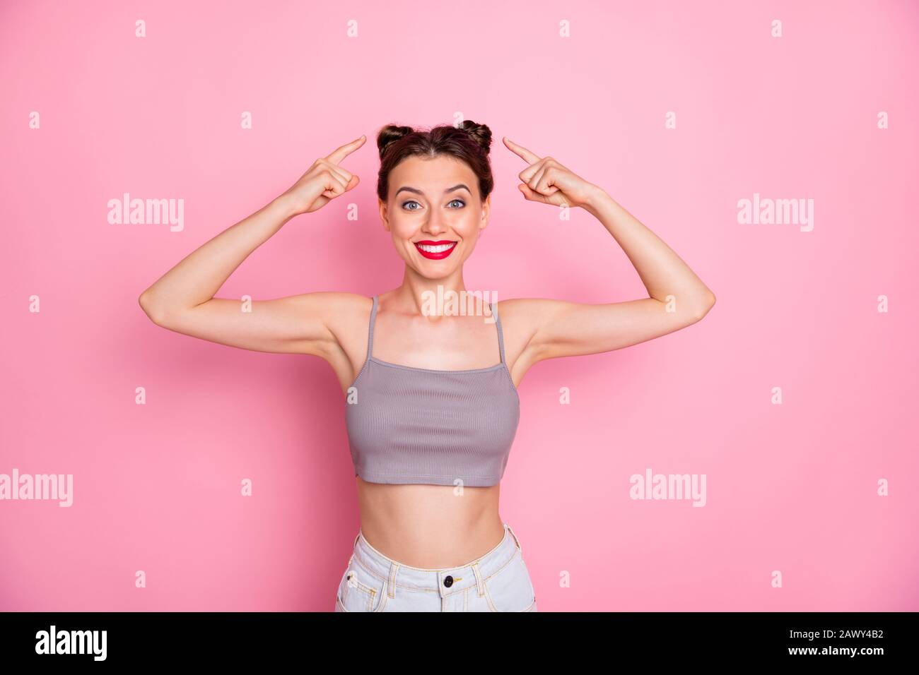 Portrait of positive cheerful girl point index finger top-knot feel ...