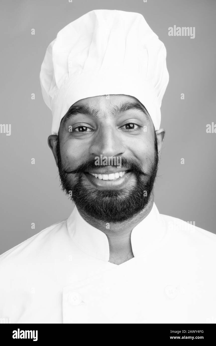 Portrait of young handsome bearded Indian man as chef Stock Photo - Alamy