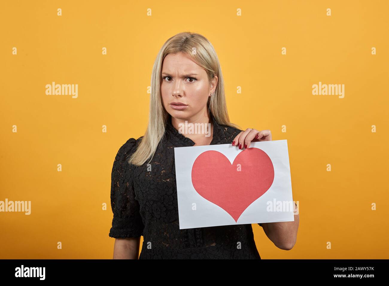 girl upset woman dissatisfied holding piece of paper with red heart ...