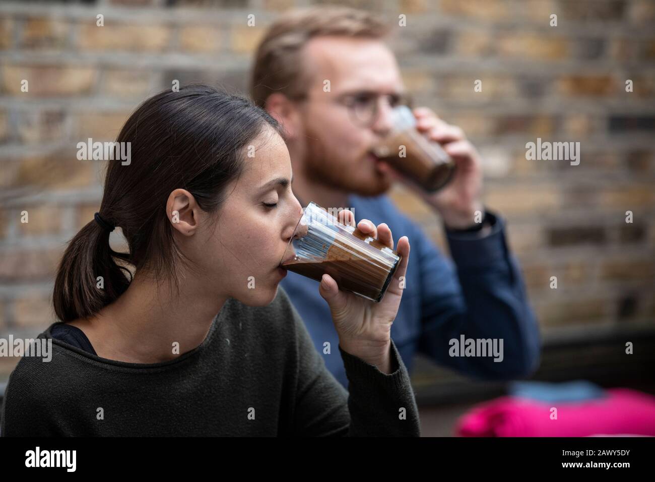 People drinking Cocoa at a Chamanic Cacao Ceremony held in the back ...
