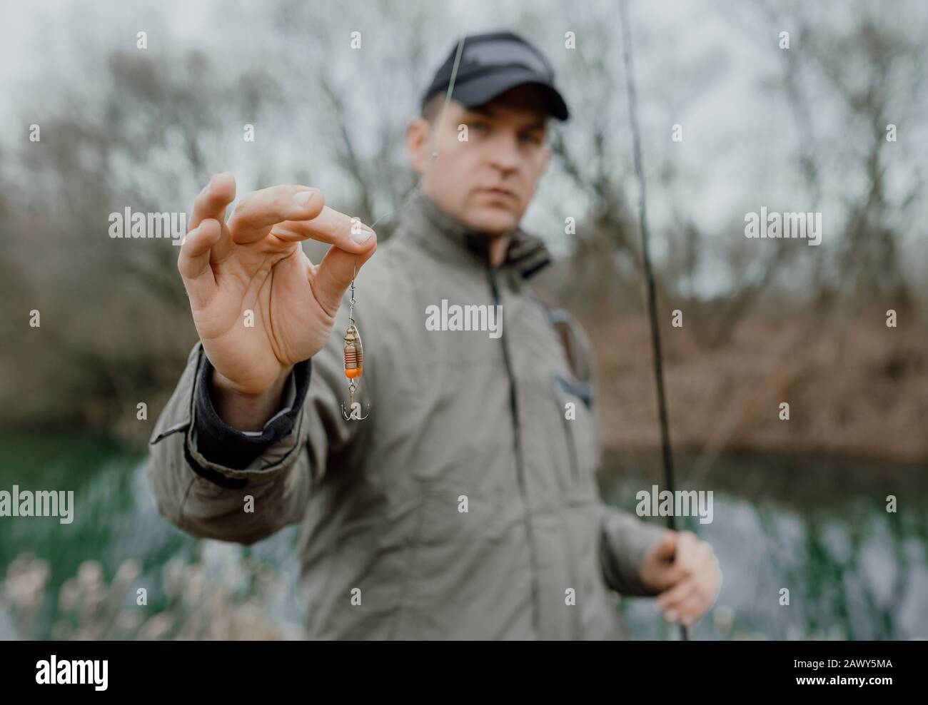 Fishing man holding bait Stock Photo - Alamy