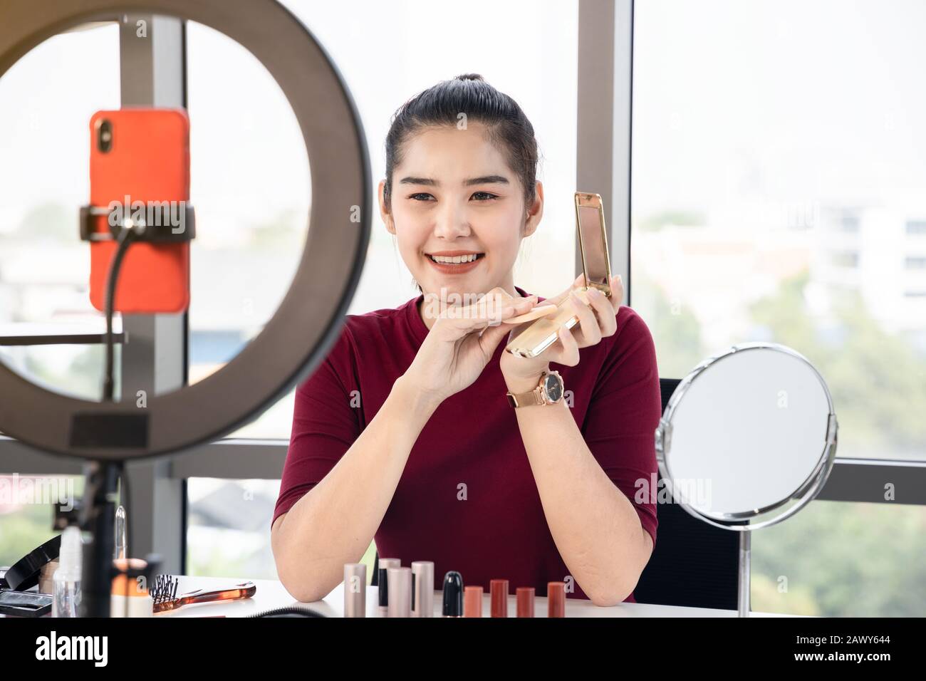 Beautiful Asian influencer review various type of cosmetics. Woman ...