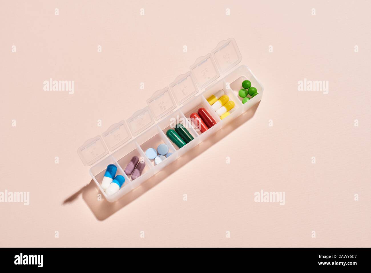 From above horizontal shot of portable plastic container for drugs with ...