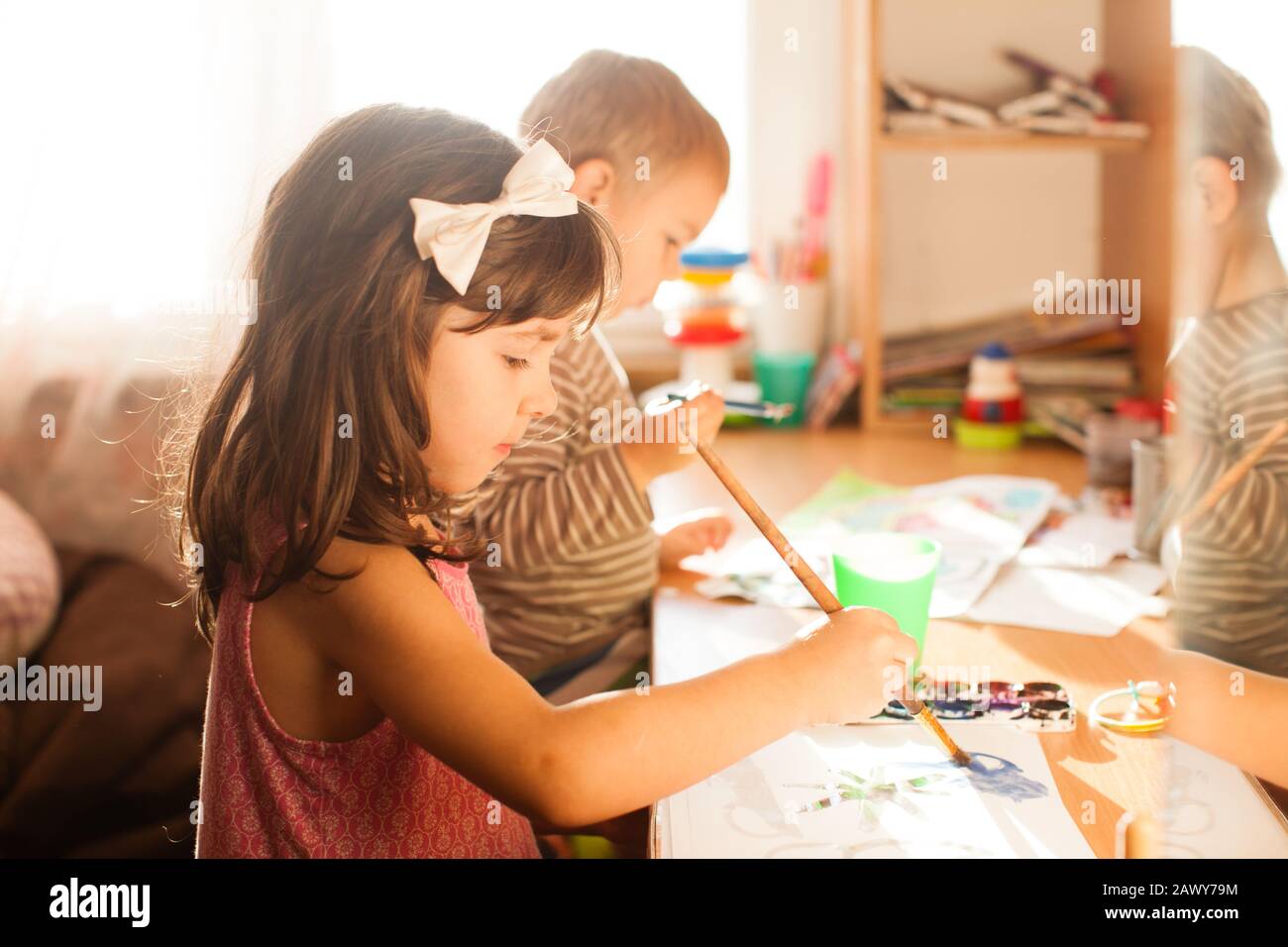 Cute kids painting with paintbrush and colorful paints Stock Photo - Alamy