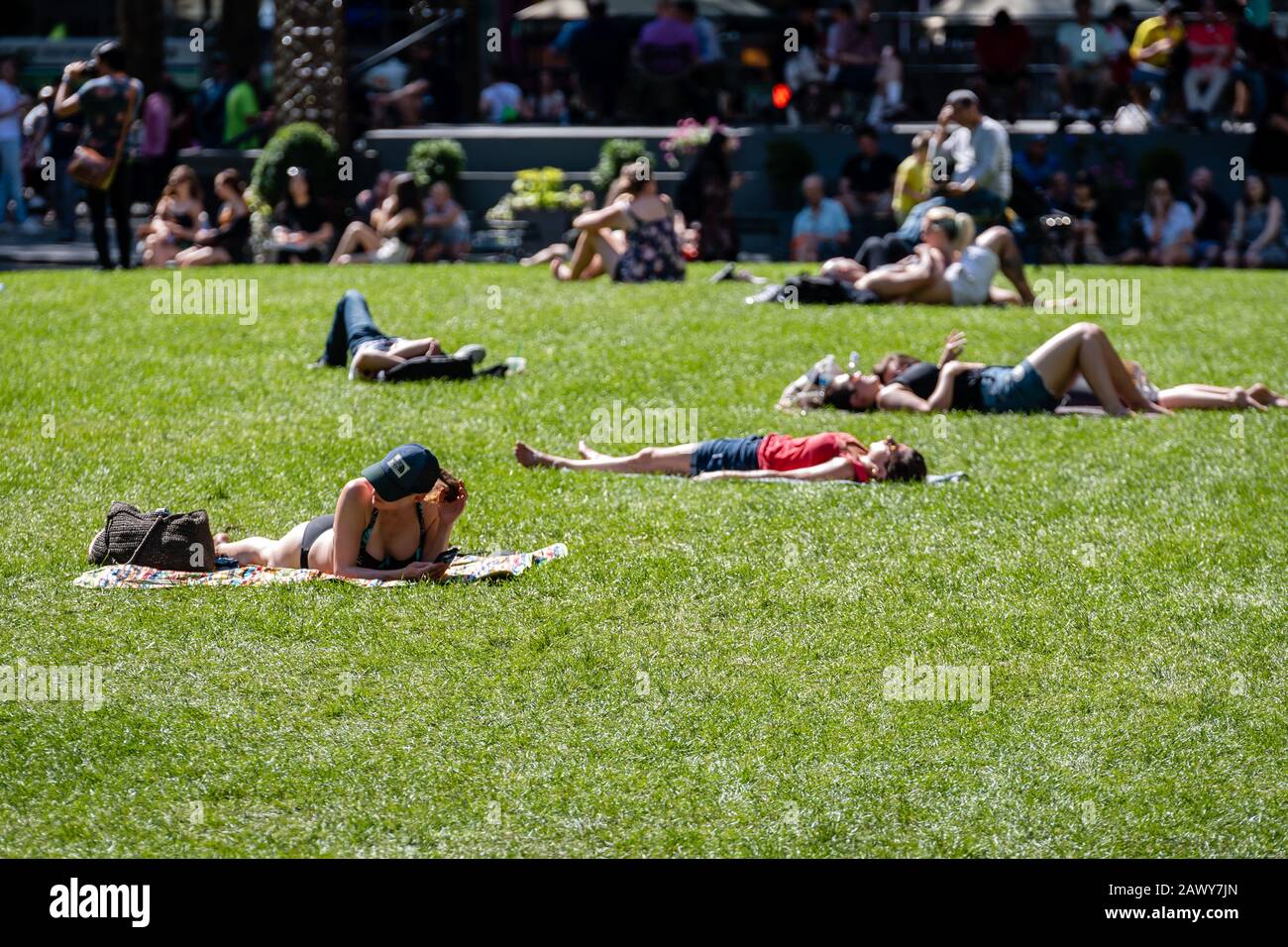 New York, USA - June 23, 2019: on a hot summer day, people sunbathe in ...