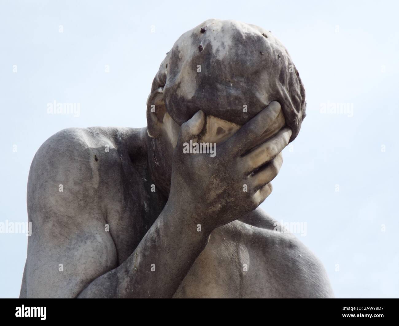 A statue holding its head in its hand Stock Photo - Alamy