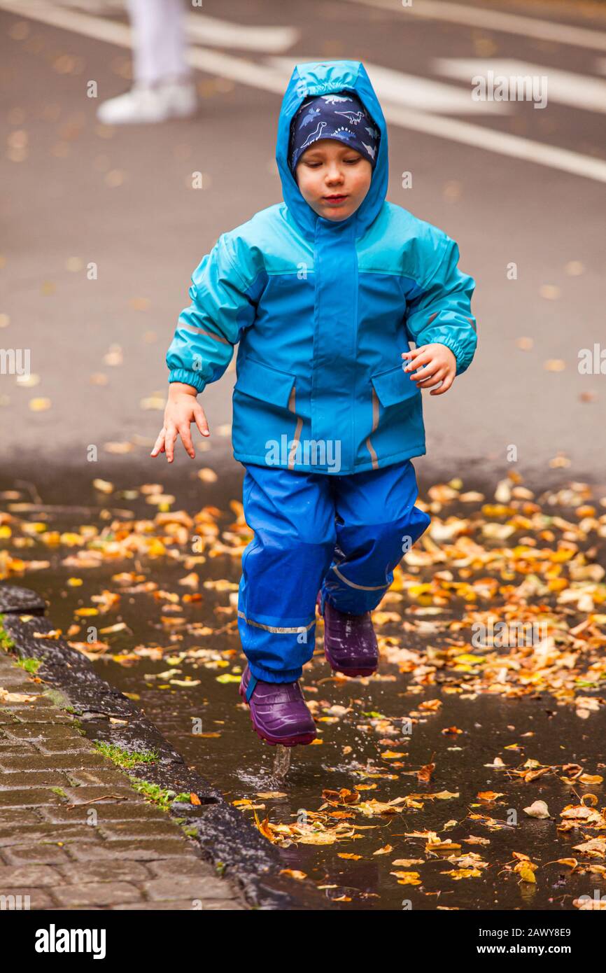 The little boy jumping in a puddle Stock Photo - Alamy