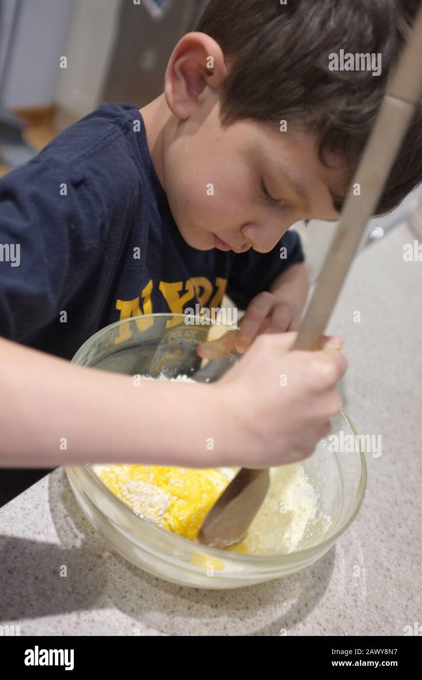 Young Boy Mixing Cake Stock Photo - Alamy