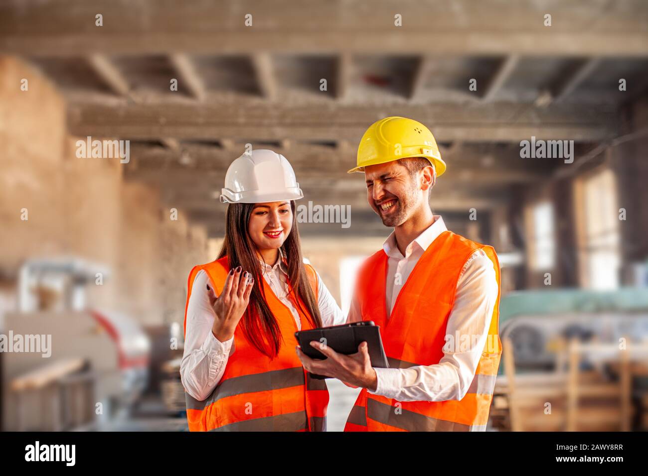 Smiling students doing practical work at factory. Professional people ...