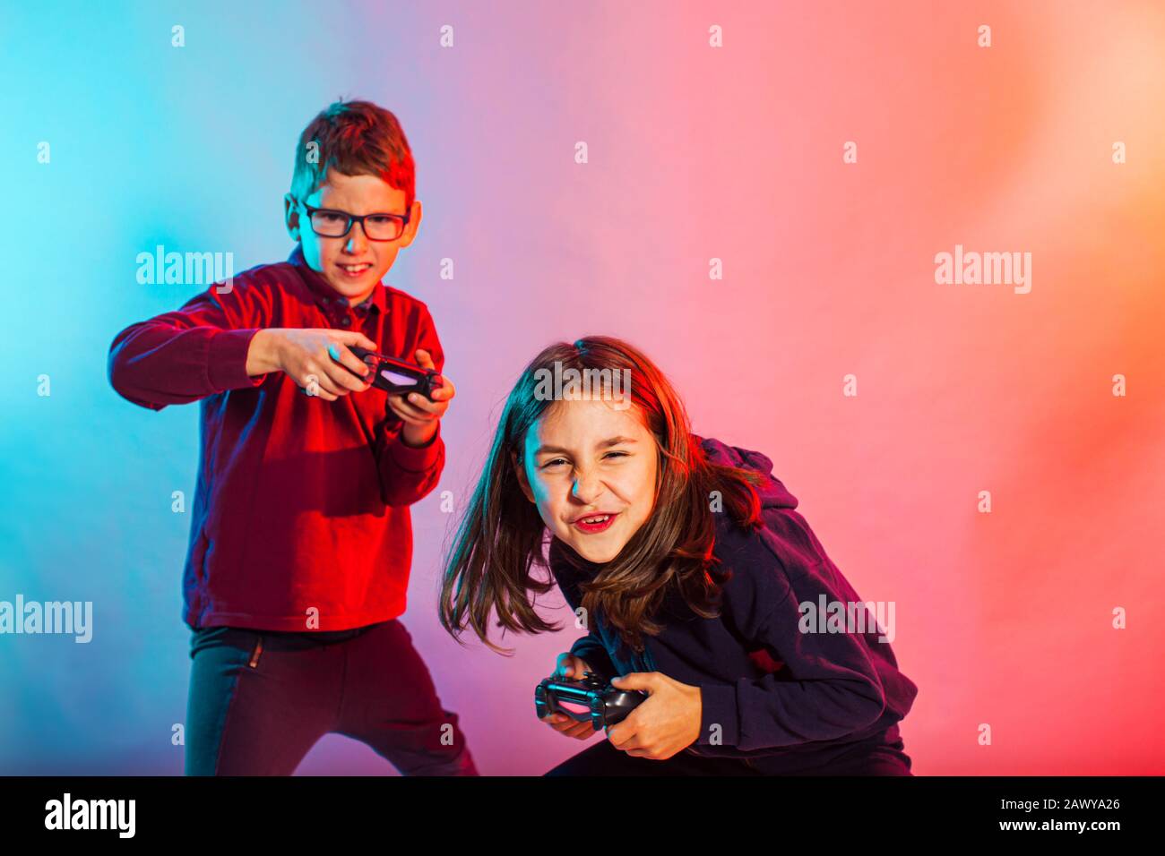 Emotional girl and boy playing virtual game Stock Photo - Alamy