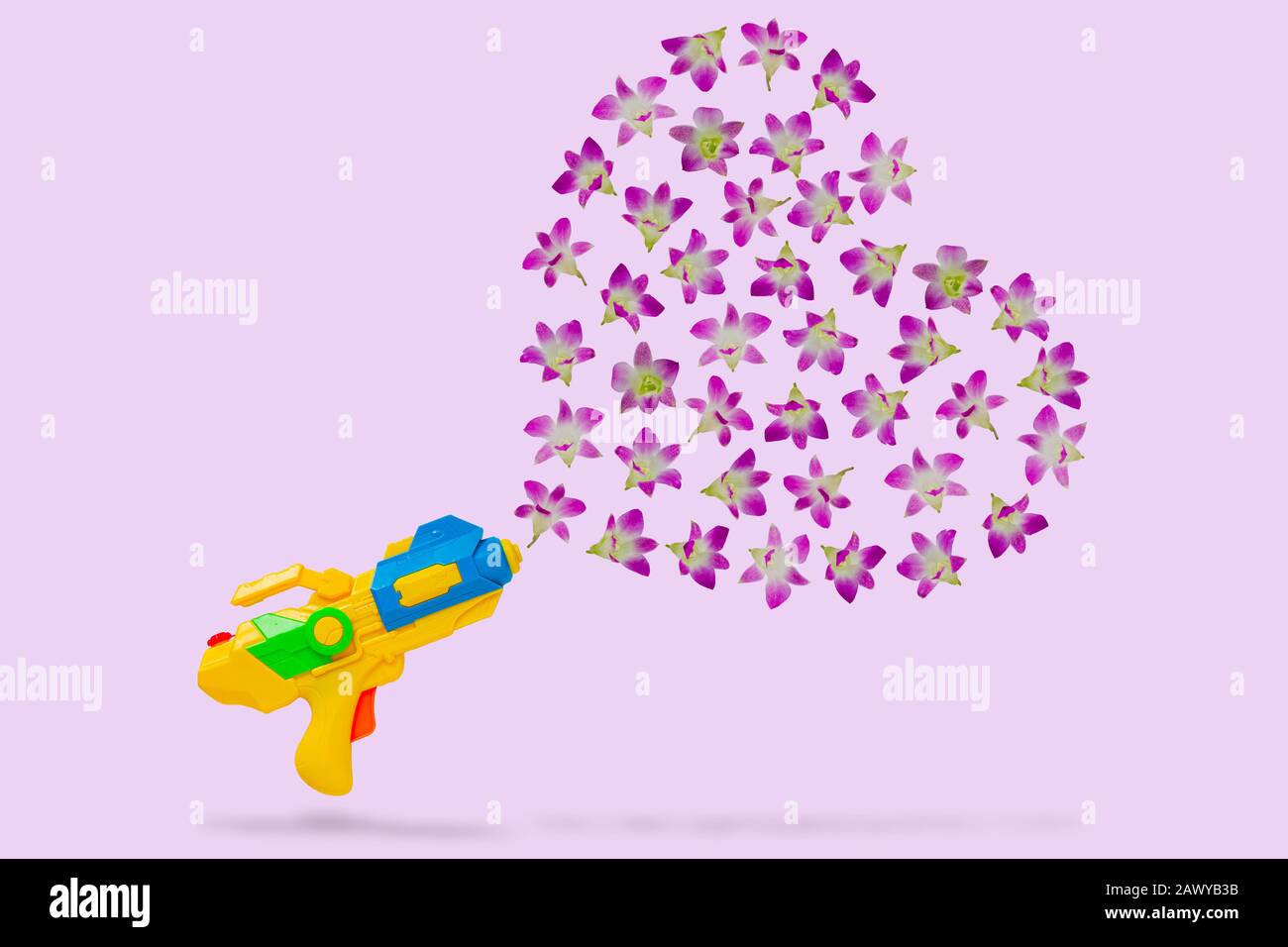 Yellow water gun with pink orchid flowers that set as splash water from ...