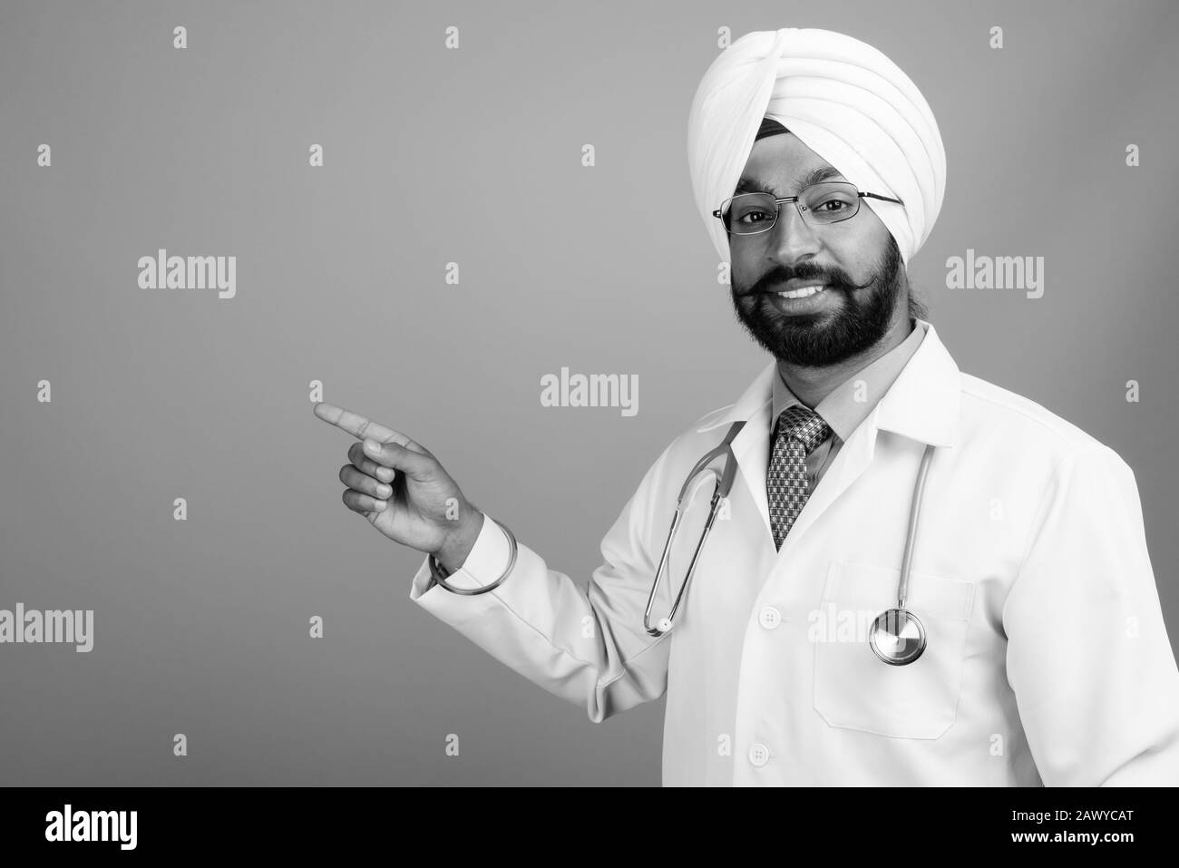 Young indian doctor smiling stethoscope Black and White Stock Photos ...
