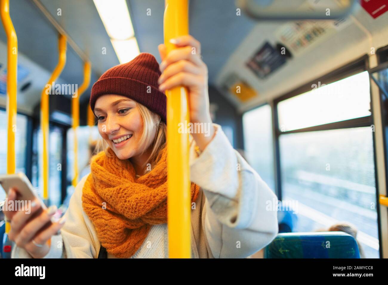 Young woman texting with smart phone on bus Stock Photo - Alamy