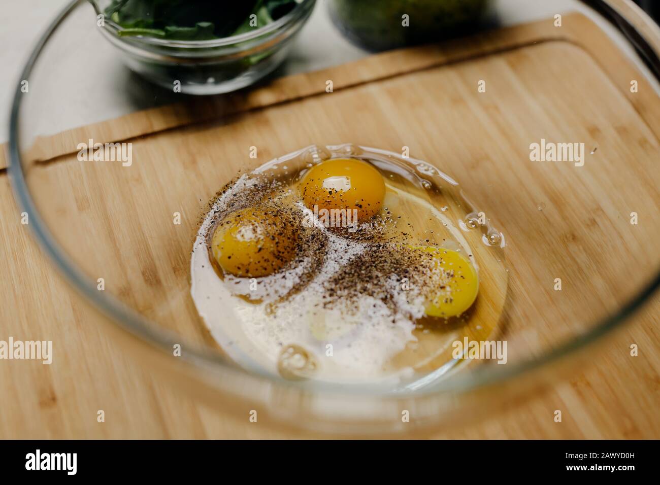 salt and pepper on fresh eggs in glass bowl Stock Photo - Alamy