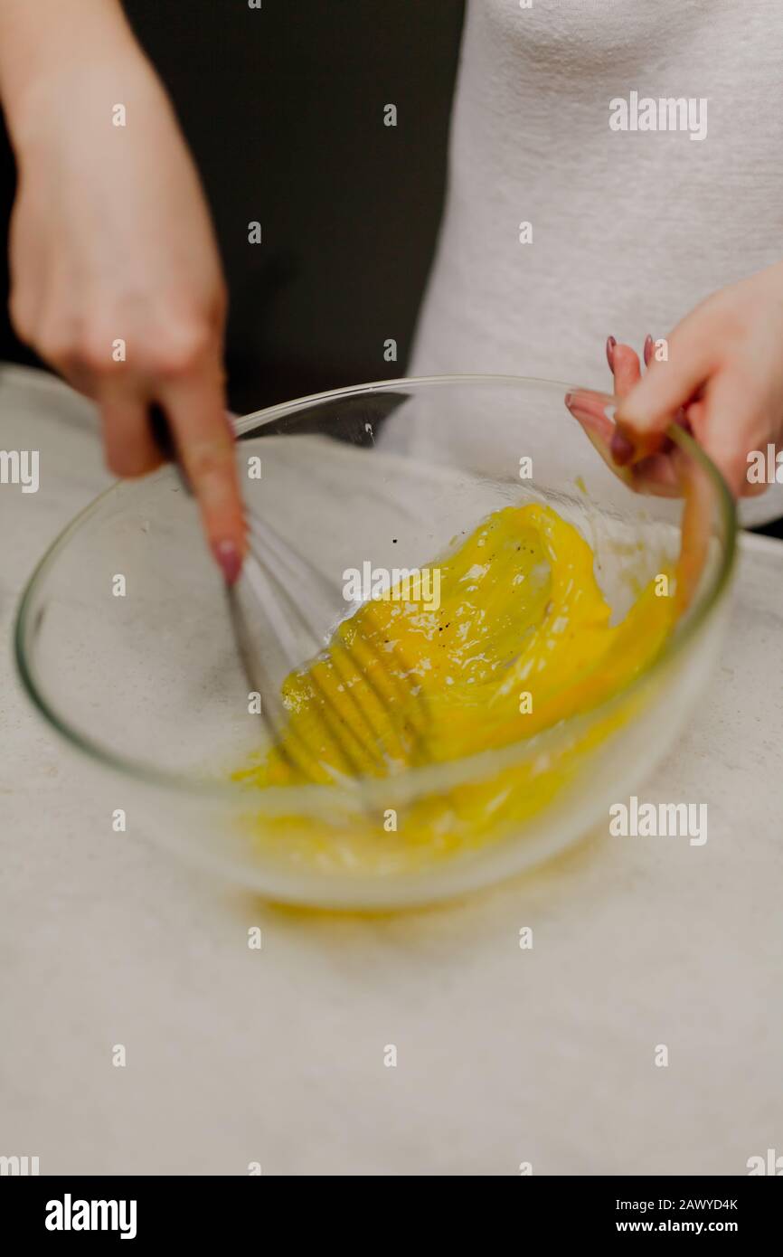 mixing eggs in glass bowl Stock Photo - Alamy