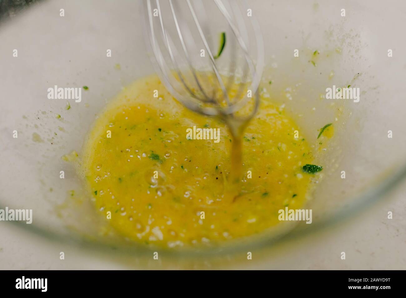 mixing eggs in glass bowl Stock Photo - Alamy