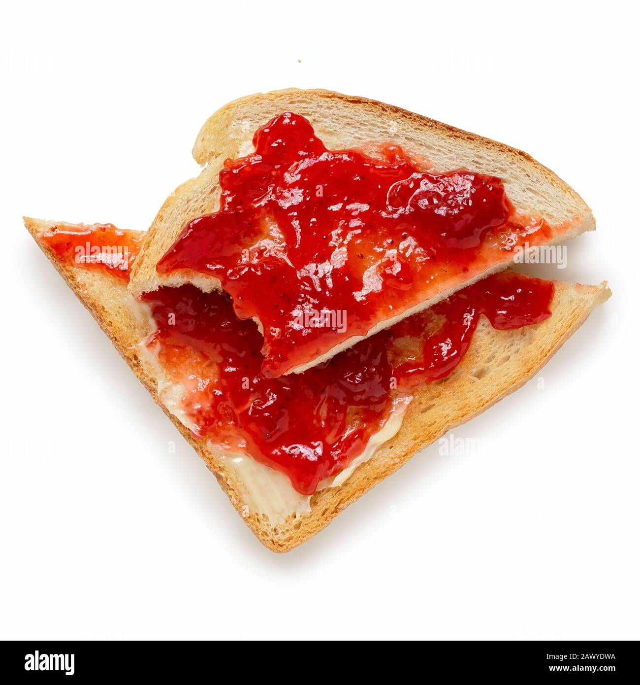 Two triangles of white toast spread with butter and strawberry jam ...