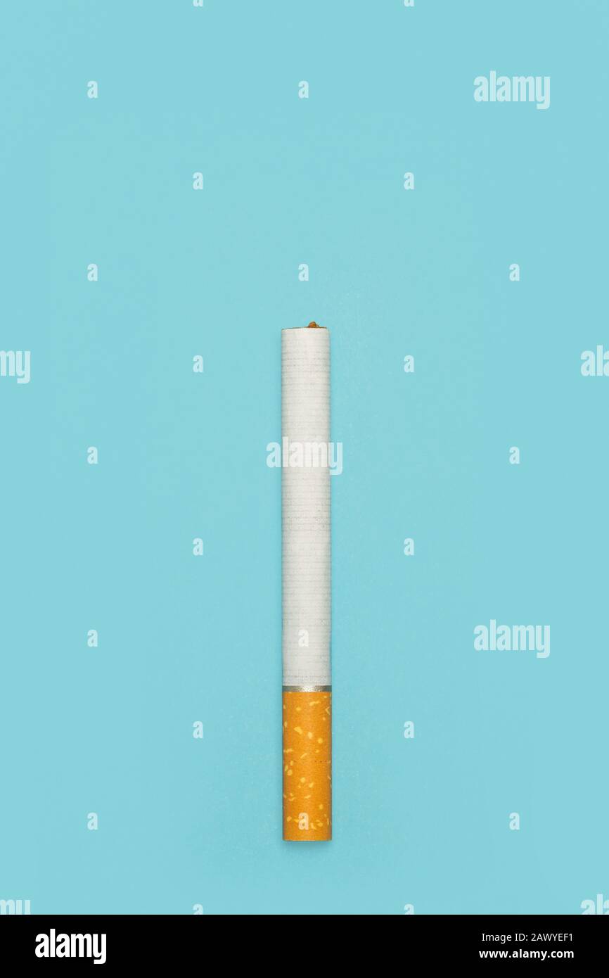 A filter cigarette on a light blue background Stock Photo - Alamy