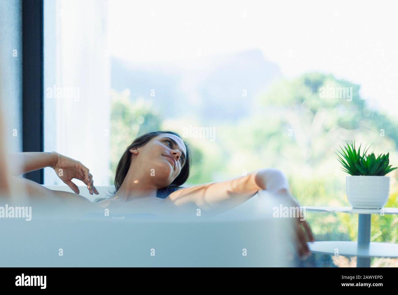 Serene woman relaxing in soaking tub Stock Photo - Alamy