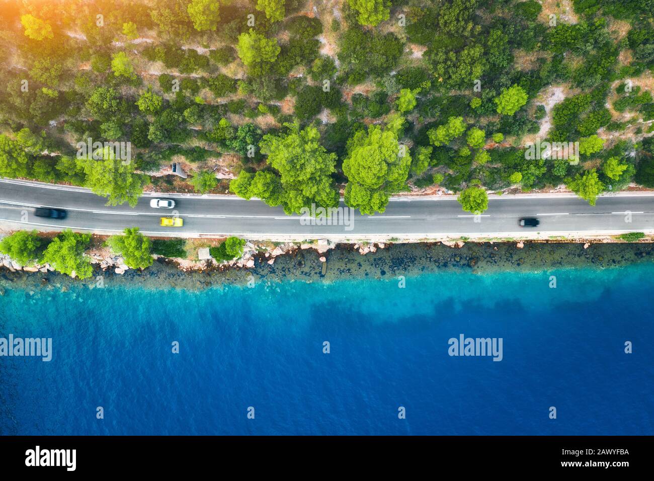 Aerial view of road in beautiful green forest and sea in spring Stock ...