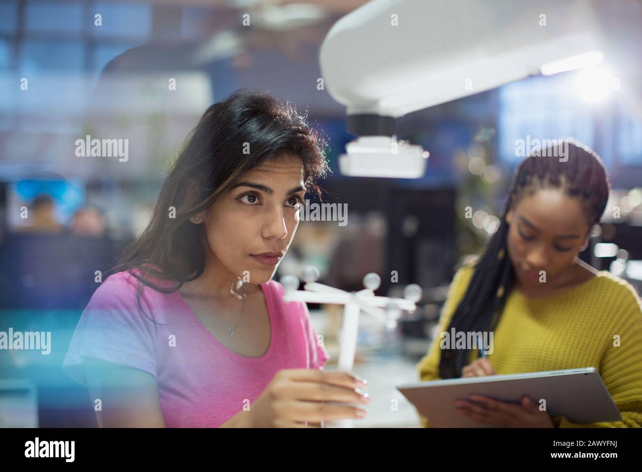 Female engineers testing robotic arm in office Stock Photo - Alamy