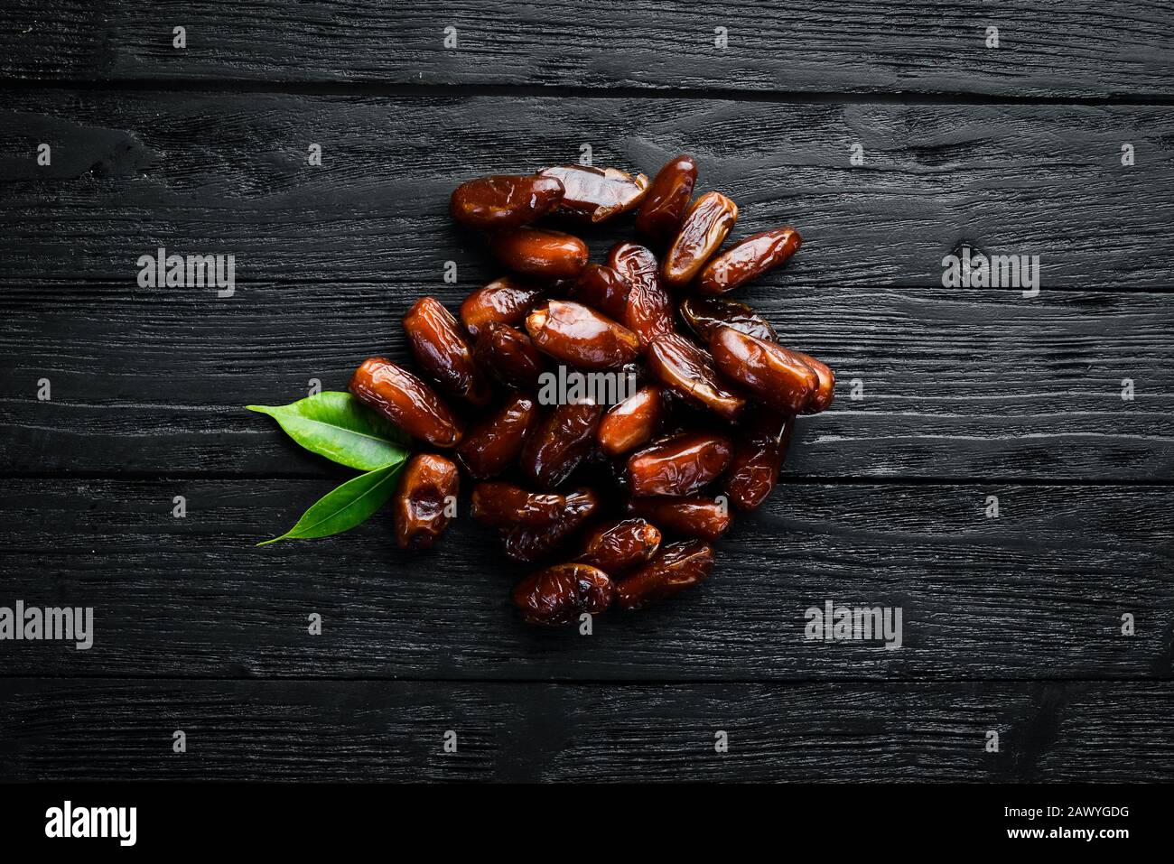Dry date on a black background. Top view. Free space for your text ...