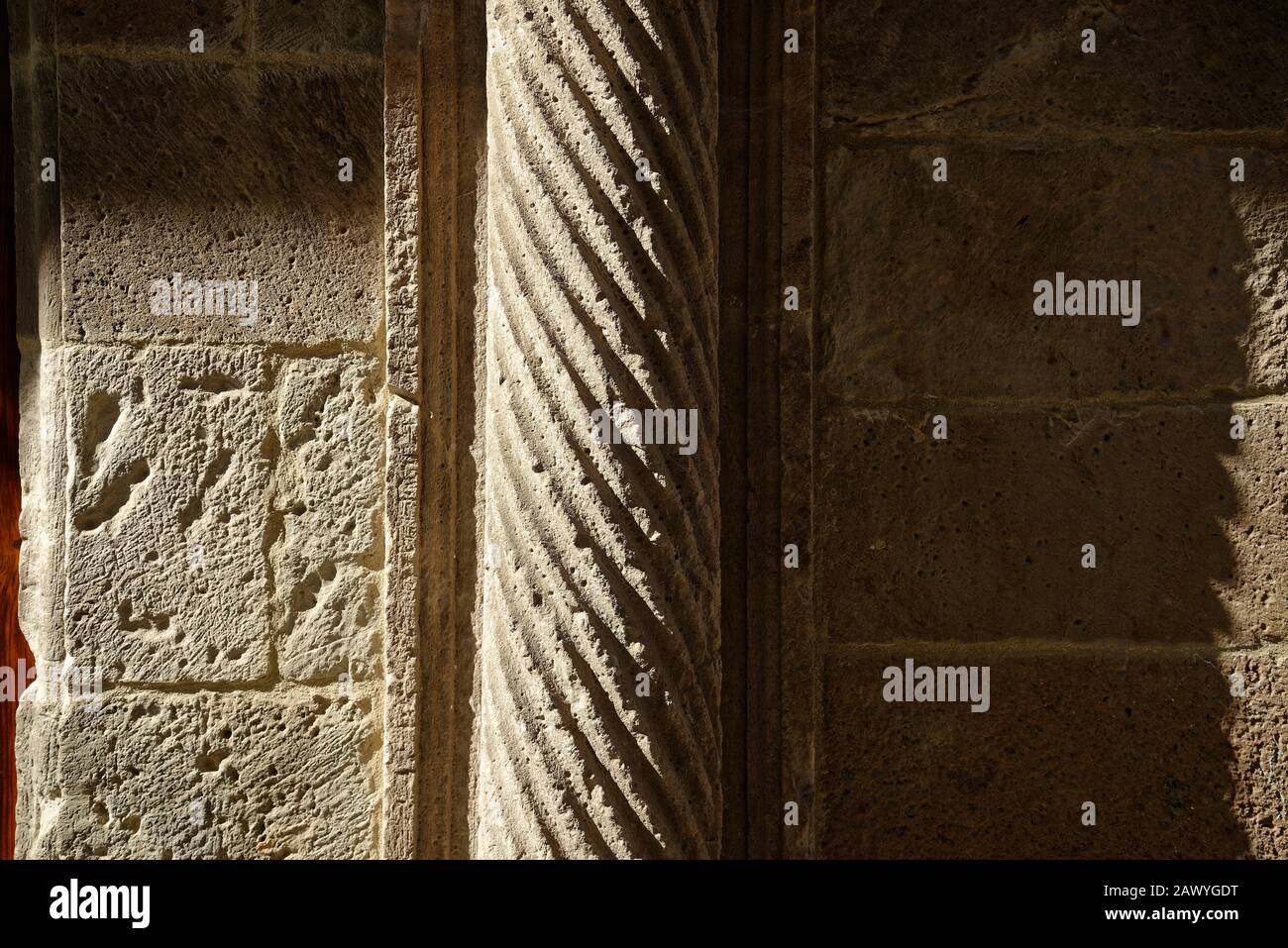 The facade of a building with a column and carved volcanic rock Stock ...