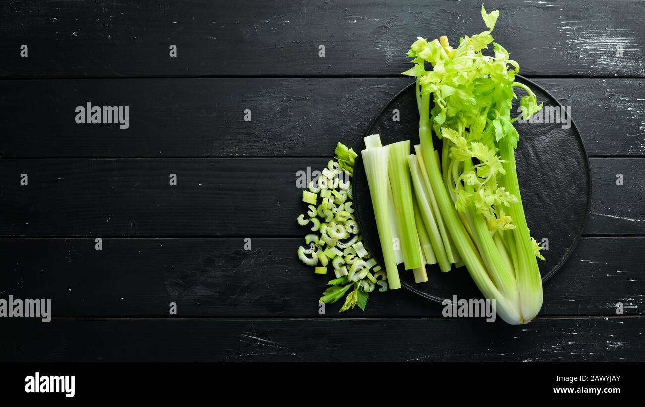 Sliced celery stalk. On a black background. Healthy food. Top view ...