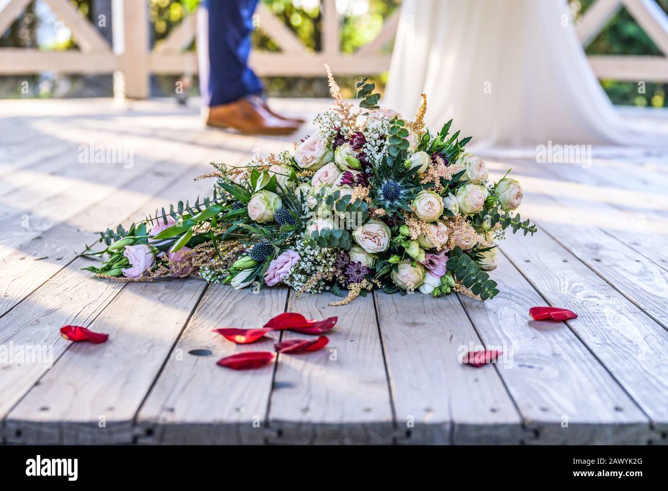 Wedding bouquet in front of newlyweds wedding couple inbackground ...