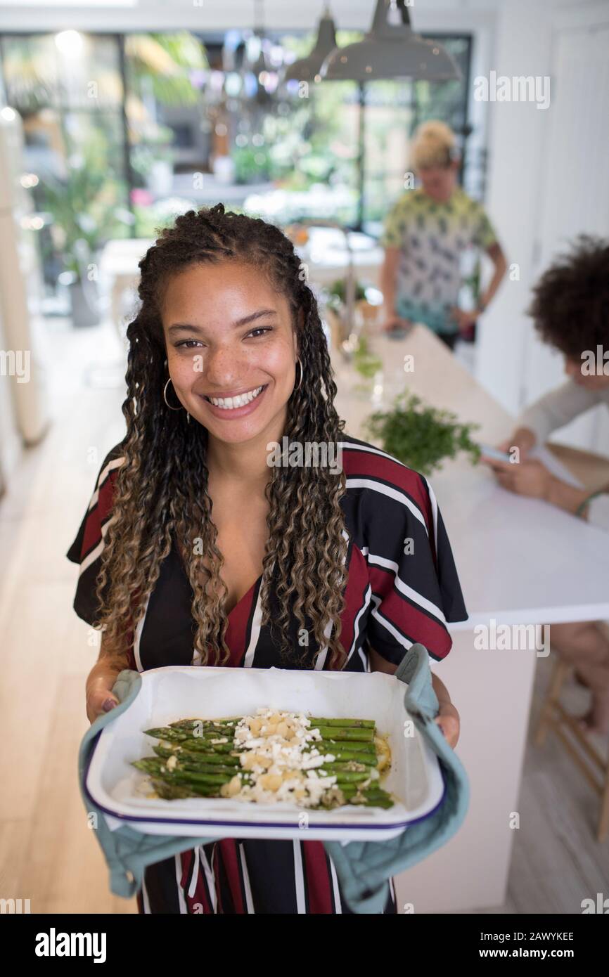 Portrait happy woman cooking asparagus in kitchen Stock Photo - Alamy