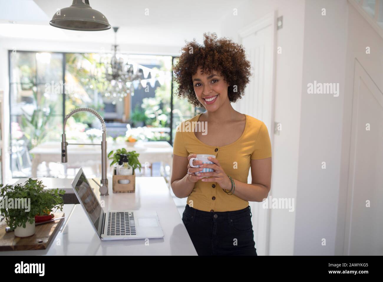 Portrait happy confident young female freelancer working at laptop ...
