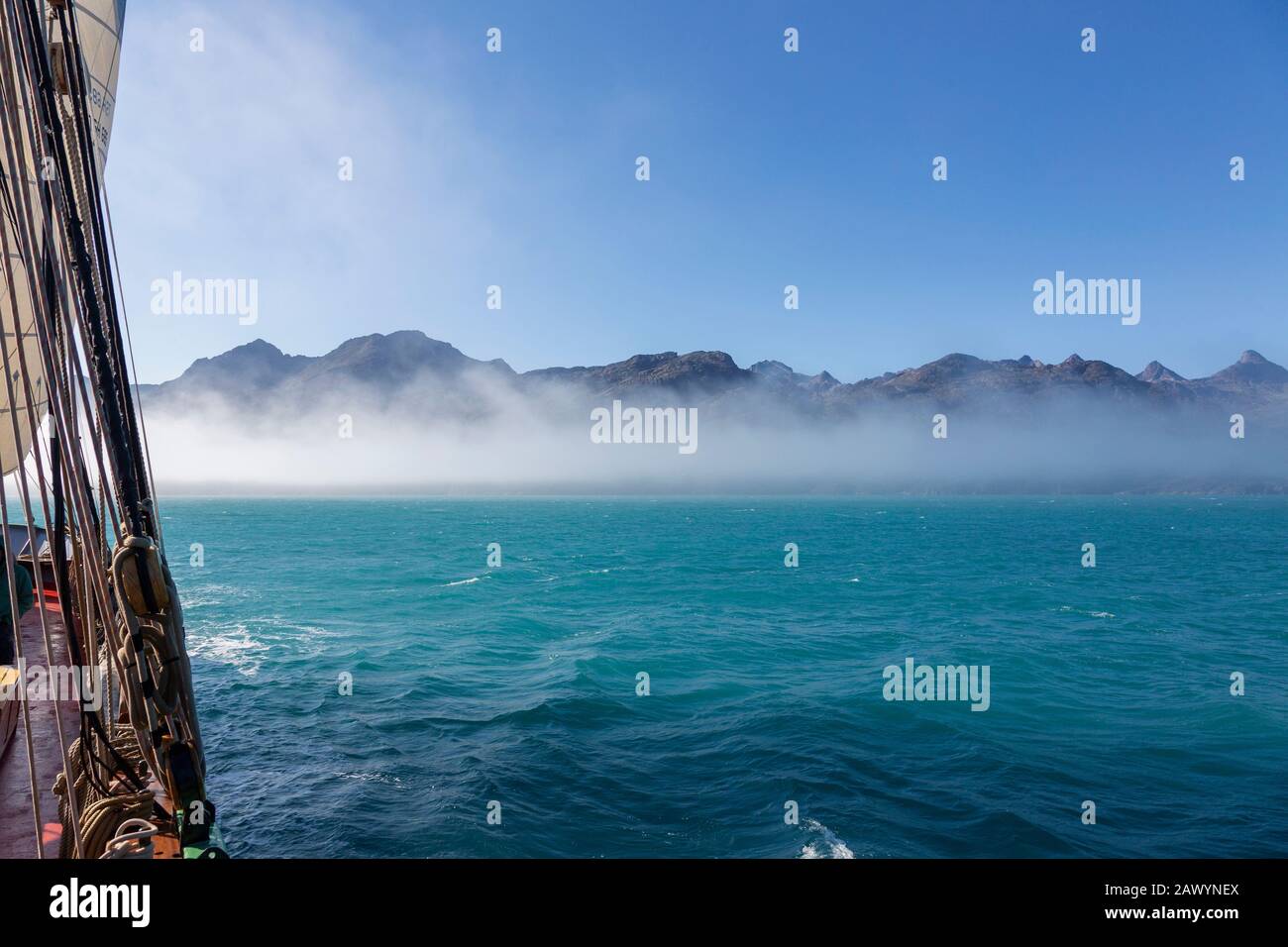 Scenic view fog clearing over mountain range Greenland Stock Photo - Alamy