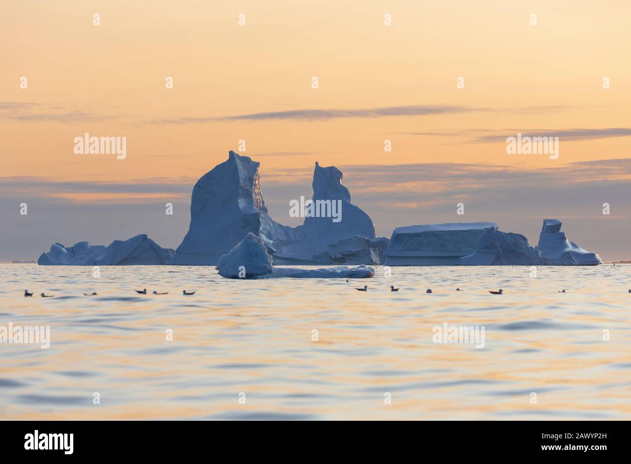 Majestic iceberg formations over sunset Atlantic Ocean Greenland Stock ...