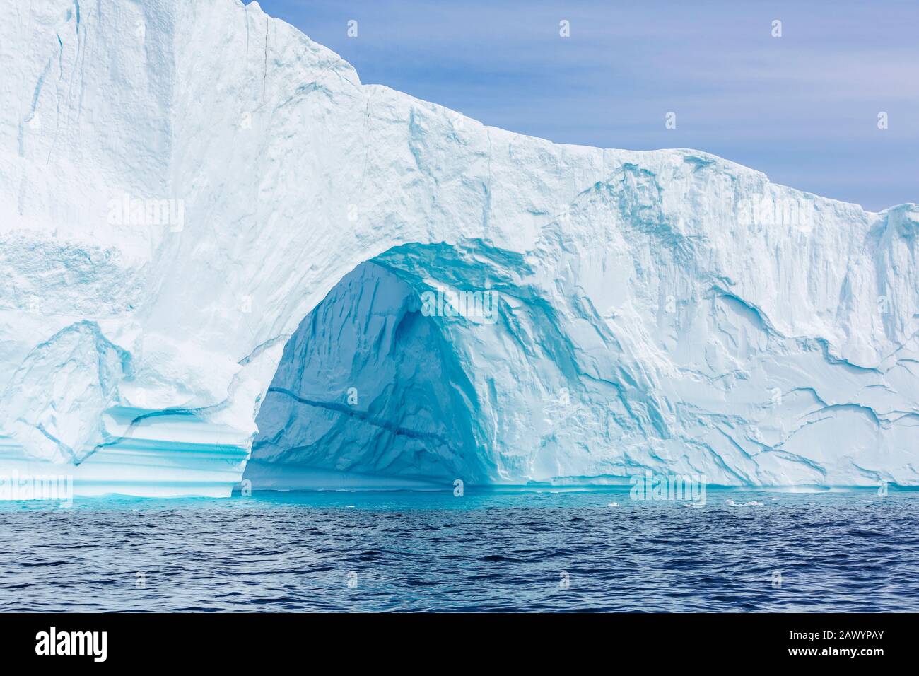 Majestic iceberg arch over sunny blue ocean Greenland Stock Photo - Alamy