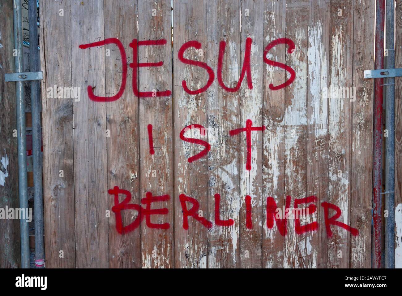 Lettering on an old wooden fence, Jesus is alive, Jesus is from Berlin ...