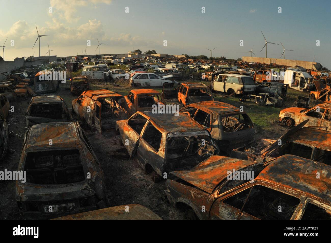 Car cemetry. Dump of old rusted cars. Metal recycling. Waste of energy ...