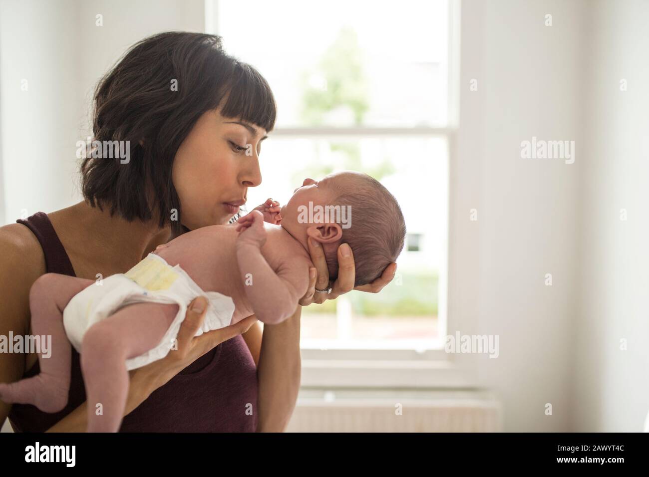 Affectionate mother holding newborn baby son Stock Photo - Alamy
