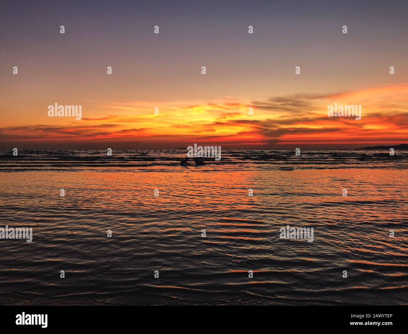 Scenery of sunset on the beach with calming waves of the ocean Stock ...