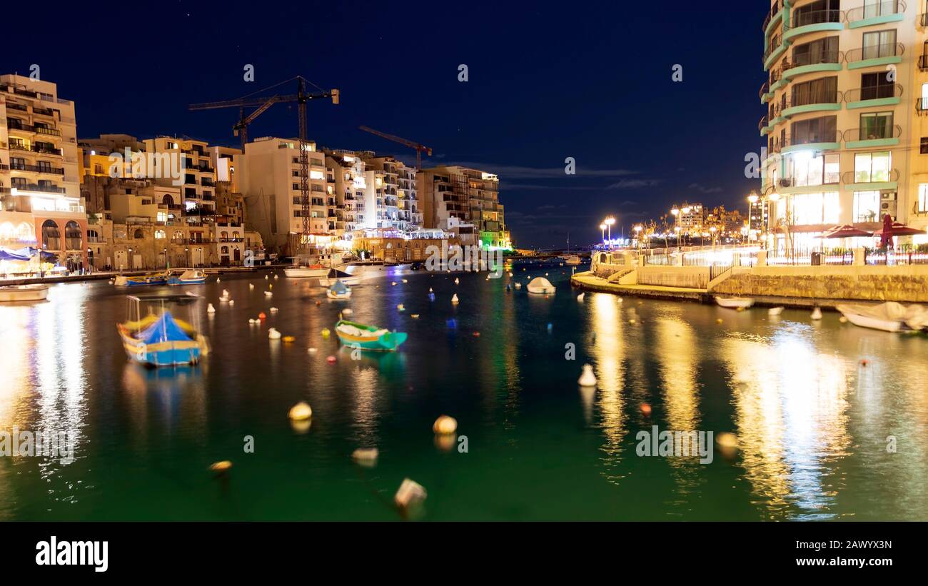 Colorful boats on the calm water of mediterranean sea bay in Malta at ...