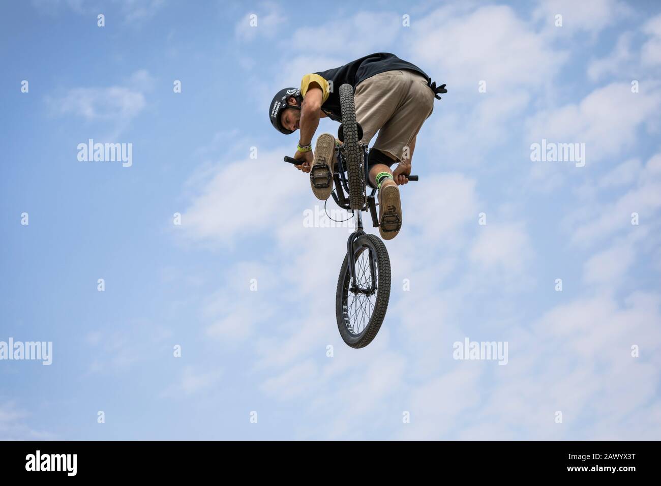 BMX rider jumping high in the air during a demonstration event at the ...
