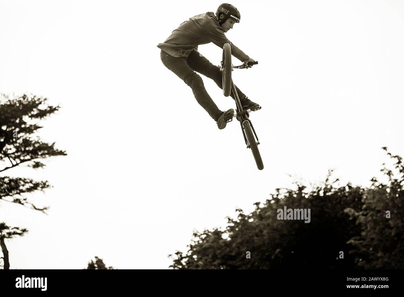 BMX rider jumping high in the air during a demonstration event at the ...