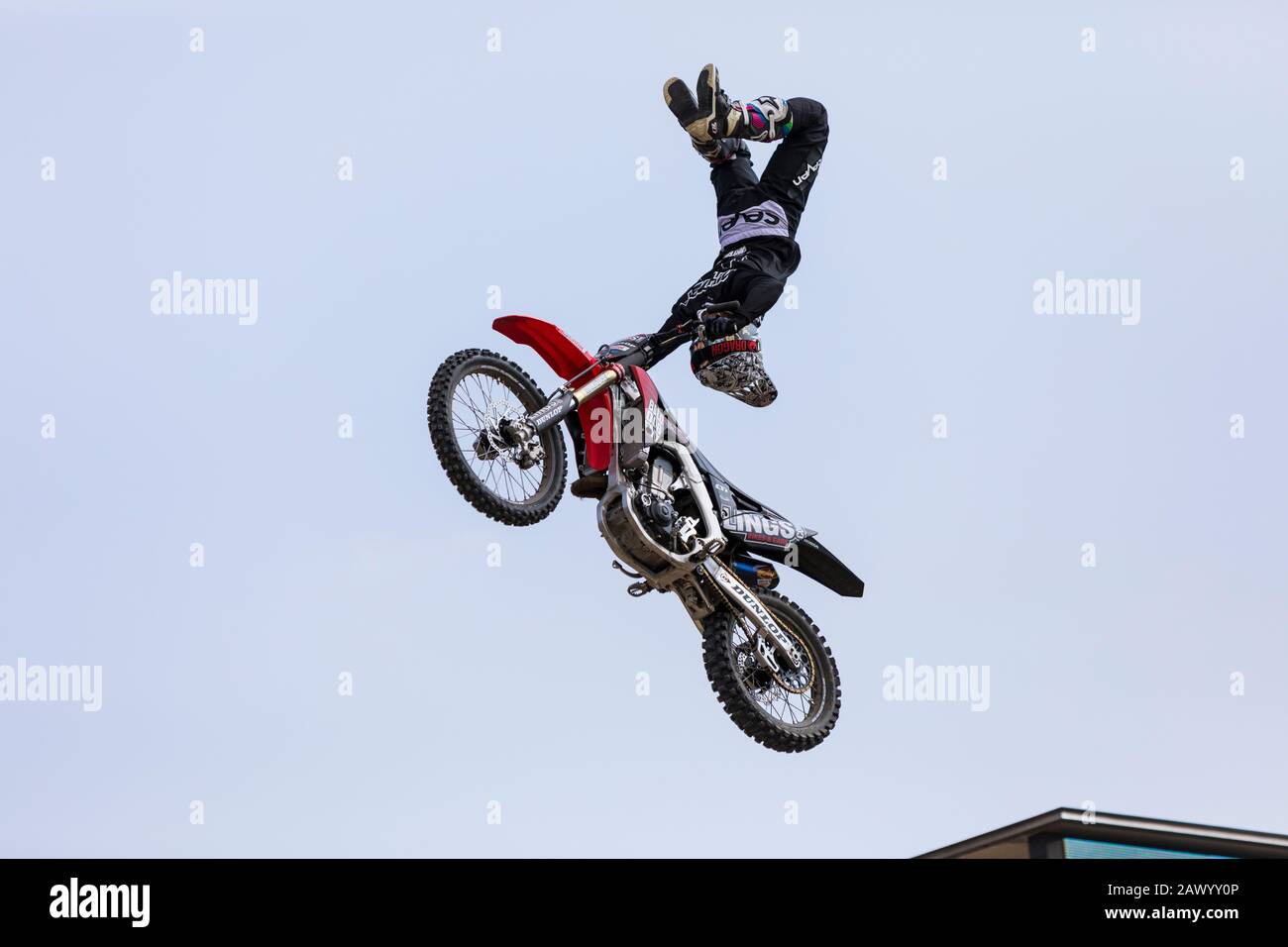 Motorcycle rider doing a handstand on the bike during a demonstration ...